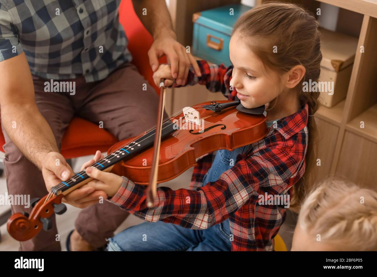 Teacher giving music lessons at school Stock Photo - Alamy