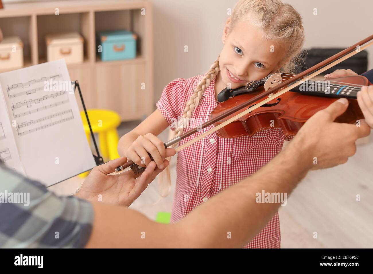 Teacher giving music lessons at school Stock Photo - Alamy