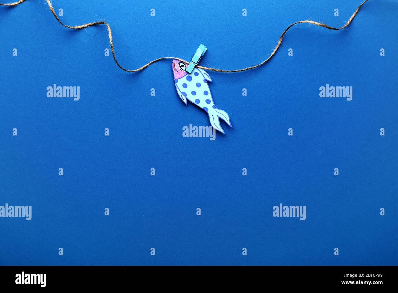 Paper fish on color background. April Fool's Day prank Stock Photo - Alamy