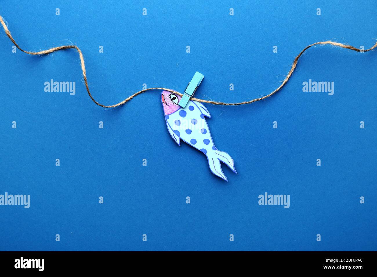 Paper fish on color background. April Fool's Day prank Stock Photo - Alamy