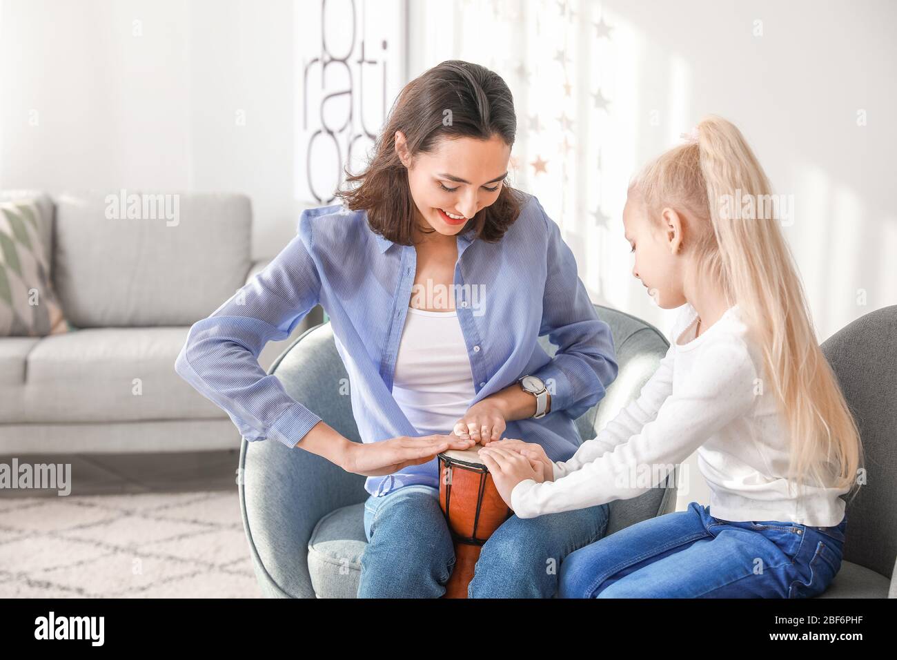 Private music teacher giving lessons to little girl at home Stock Photo ...
