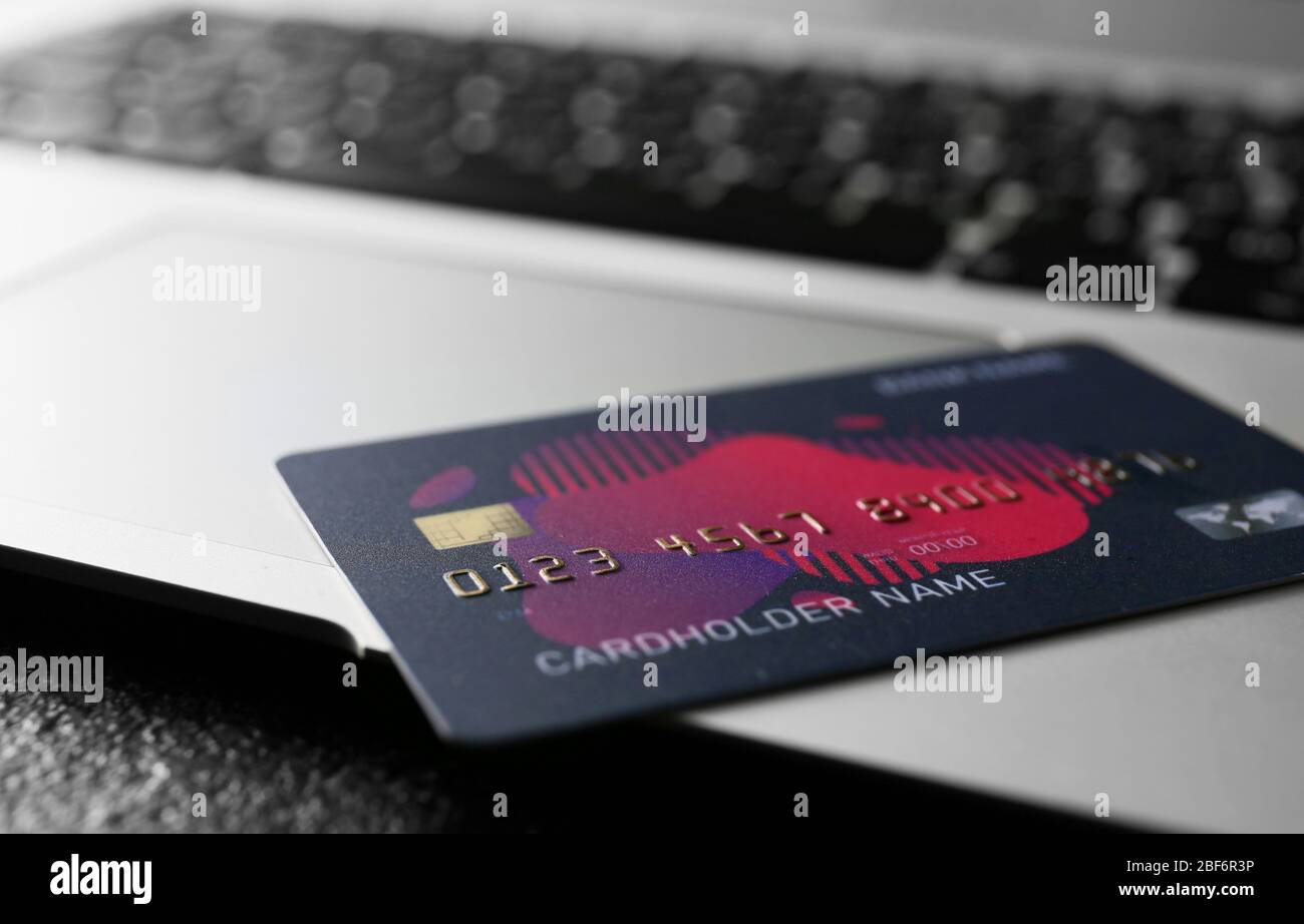Credit card with laptop, closeup Stock Photo - Alamy