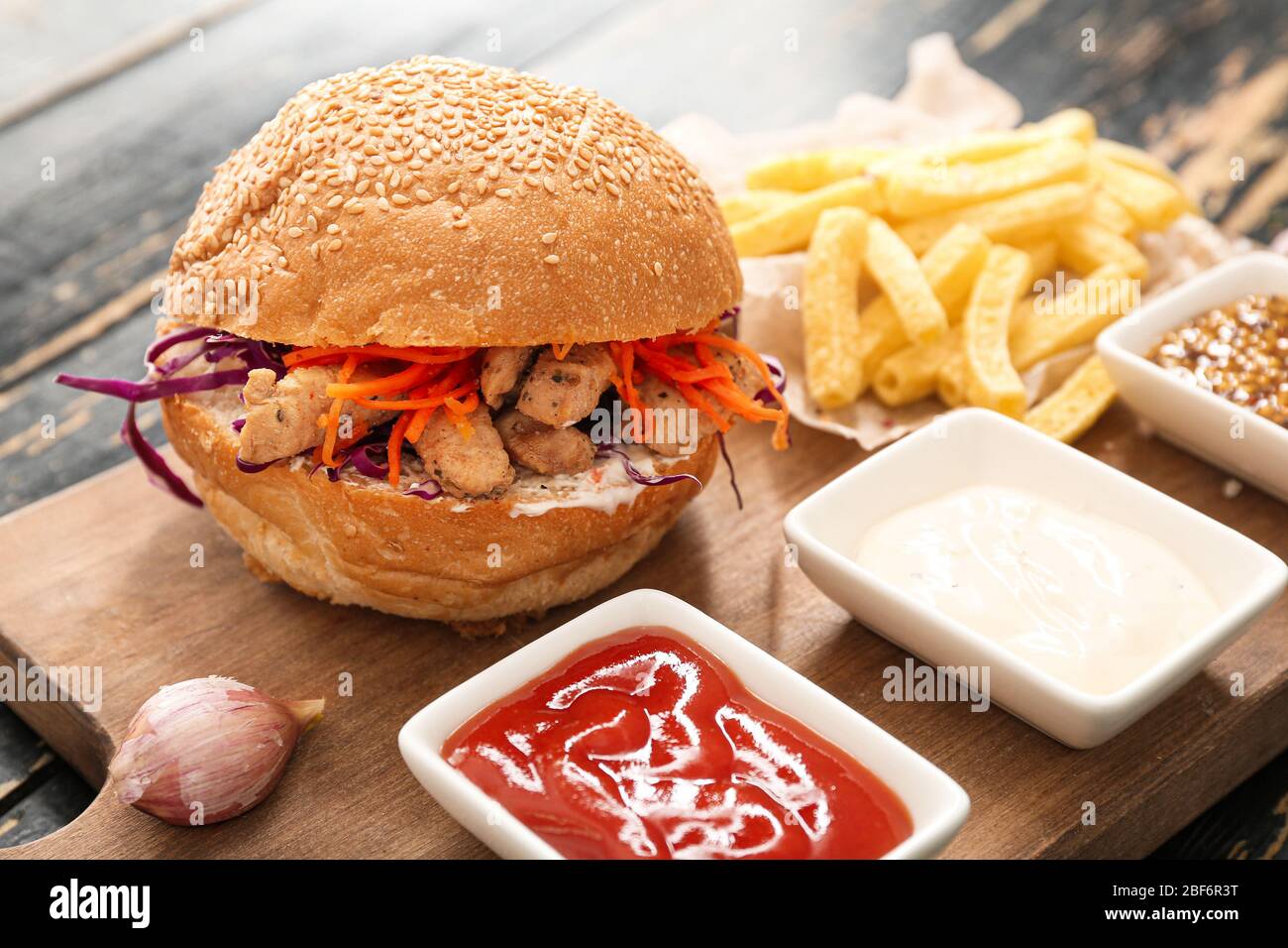 Tasty doner kebab with french fries and sauces n table Stock Photo - Alamy