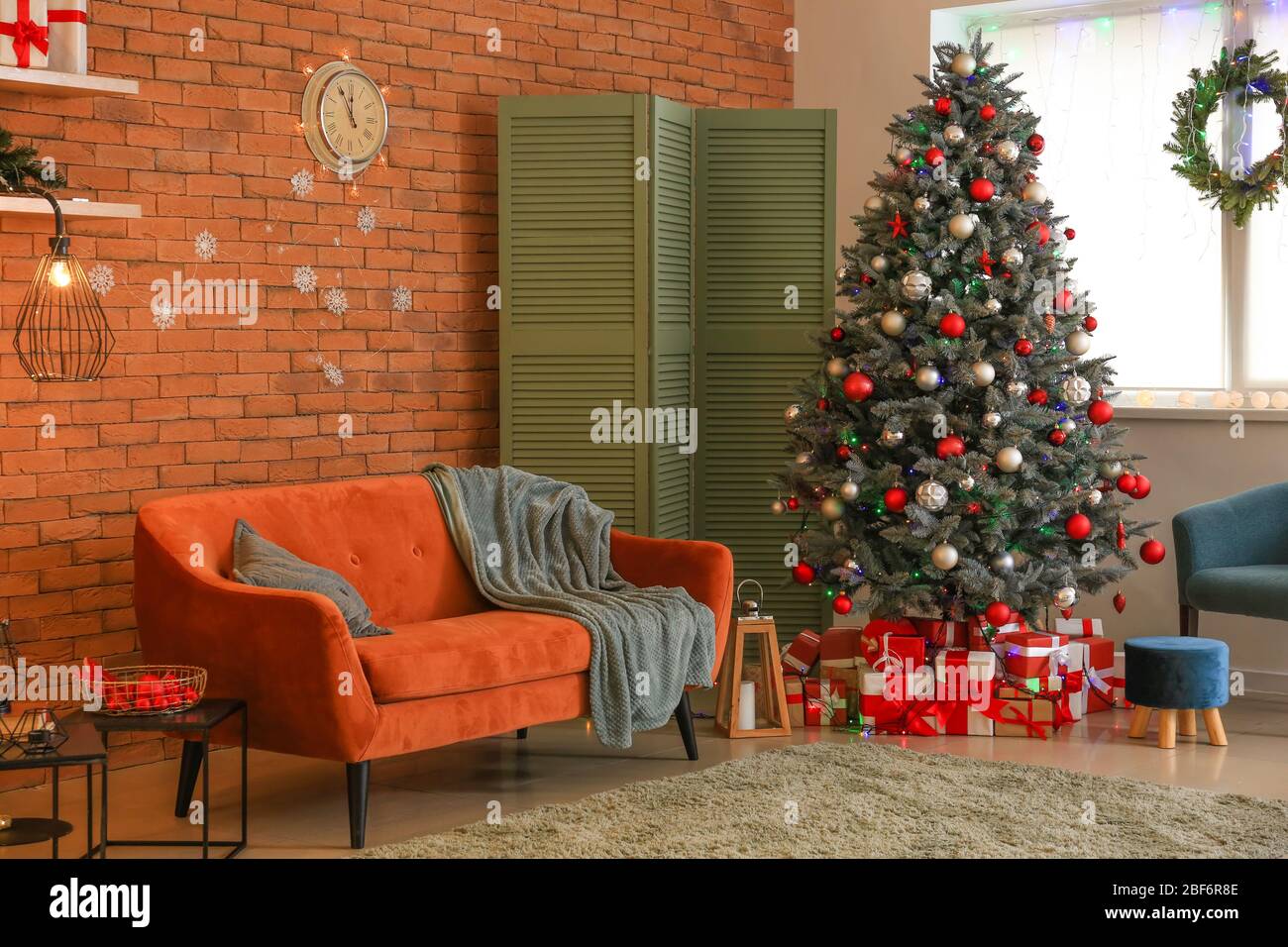 Interior of room with Christmas tree and sofa Stock Photo - Alamy