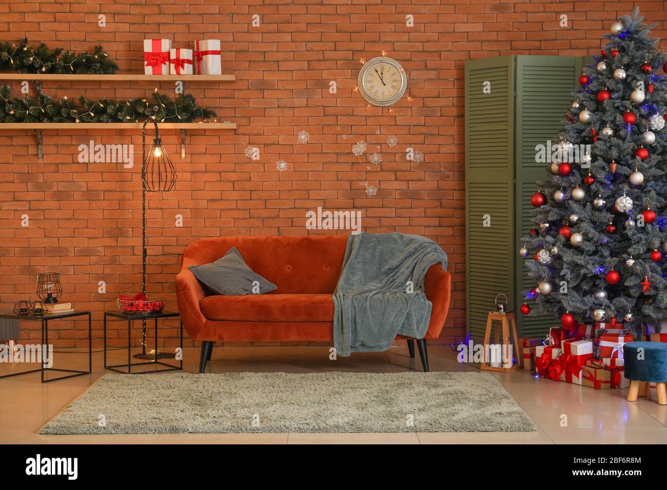 Interior of room with Christmas tree and sofa Stock Photo - Alamy
