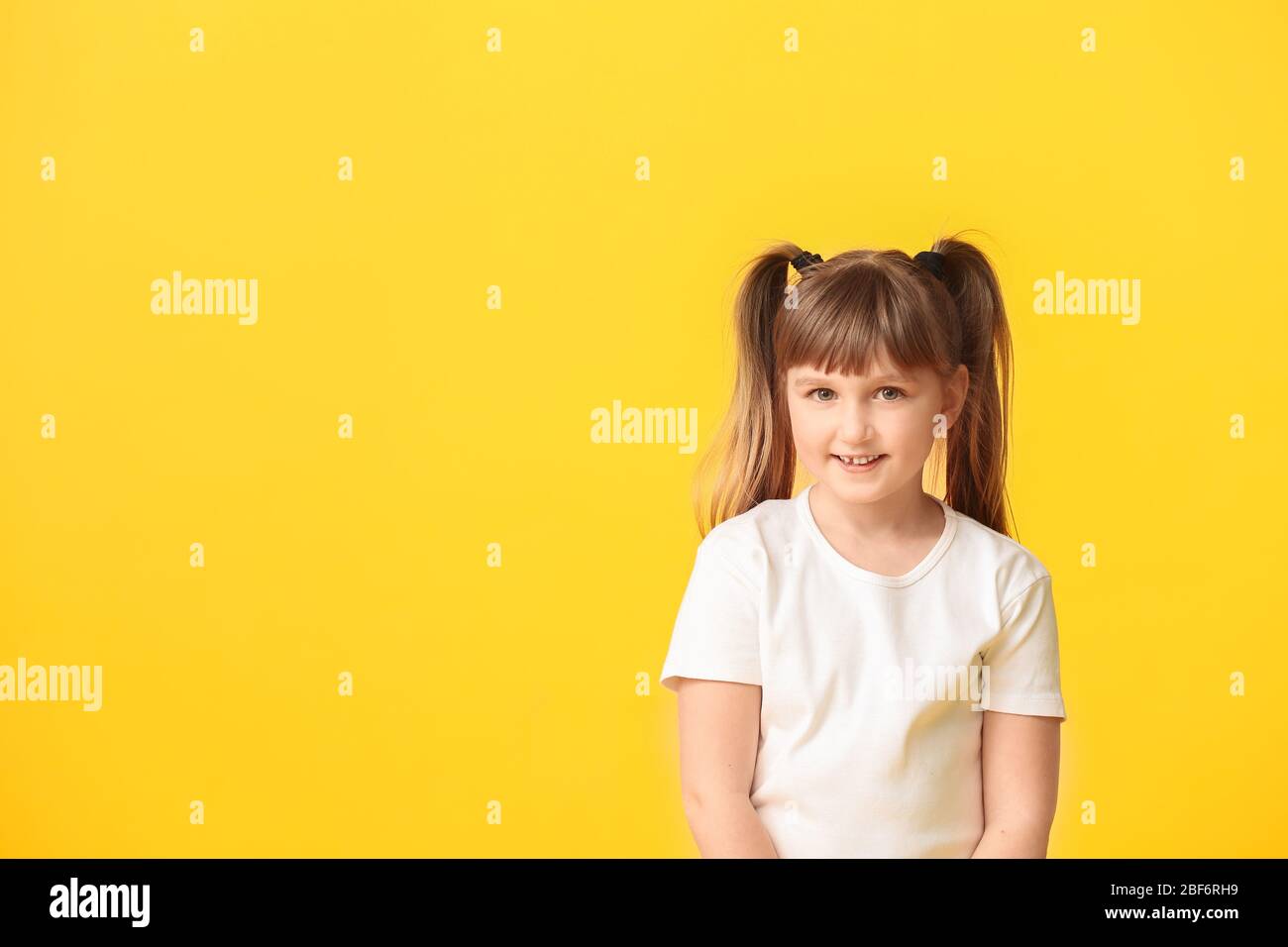 Cute little girl on color background Stock Photo - Alamy