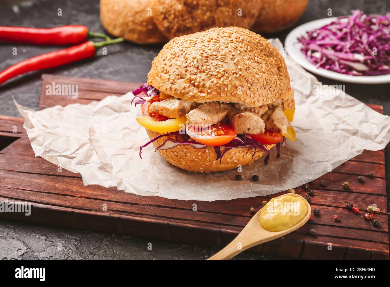 Tasty doner kebab in bun and sauce on table Stock Photo - Alamy