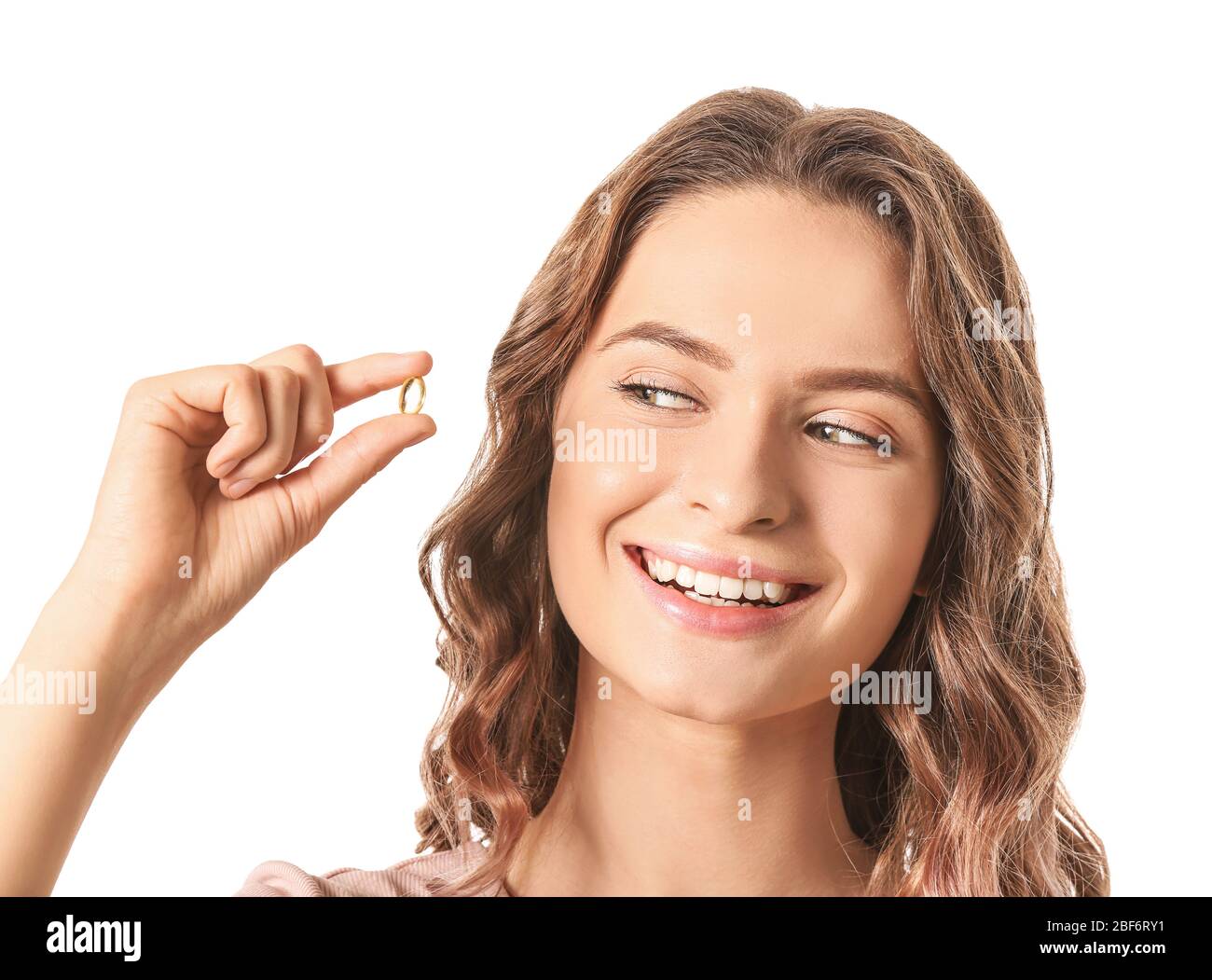 Young woman with fish oil on white background Stock Photo - Alamy
