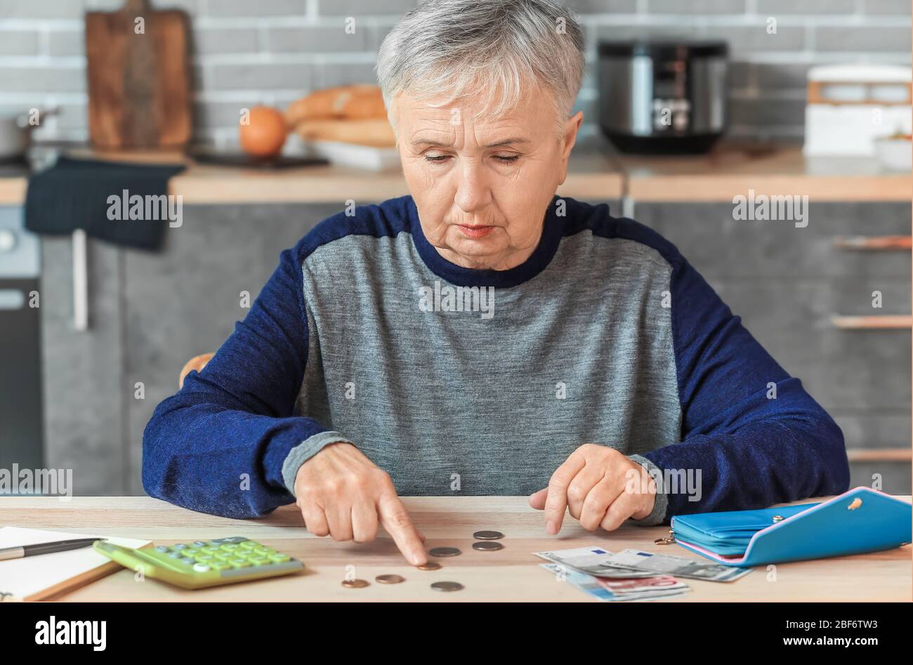 Senior woman counting money at home Stock Photo - Alamy