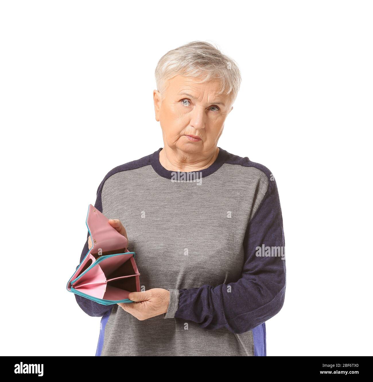 Senior woman with empty wallet on white background Stock Photo - Alamy