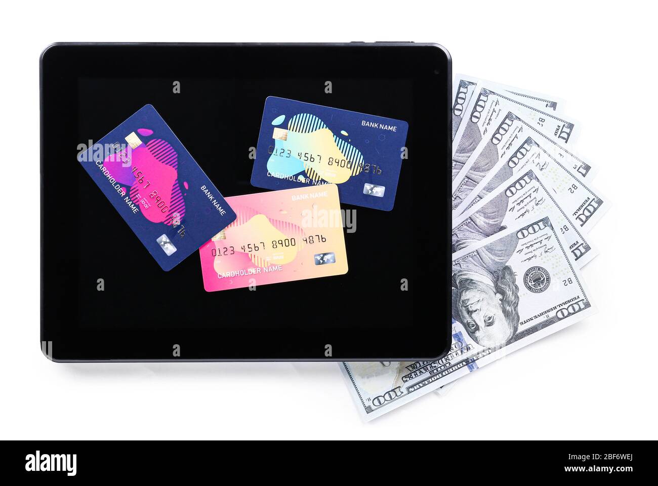 Credit cards with money and tablet computer on white background ...