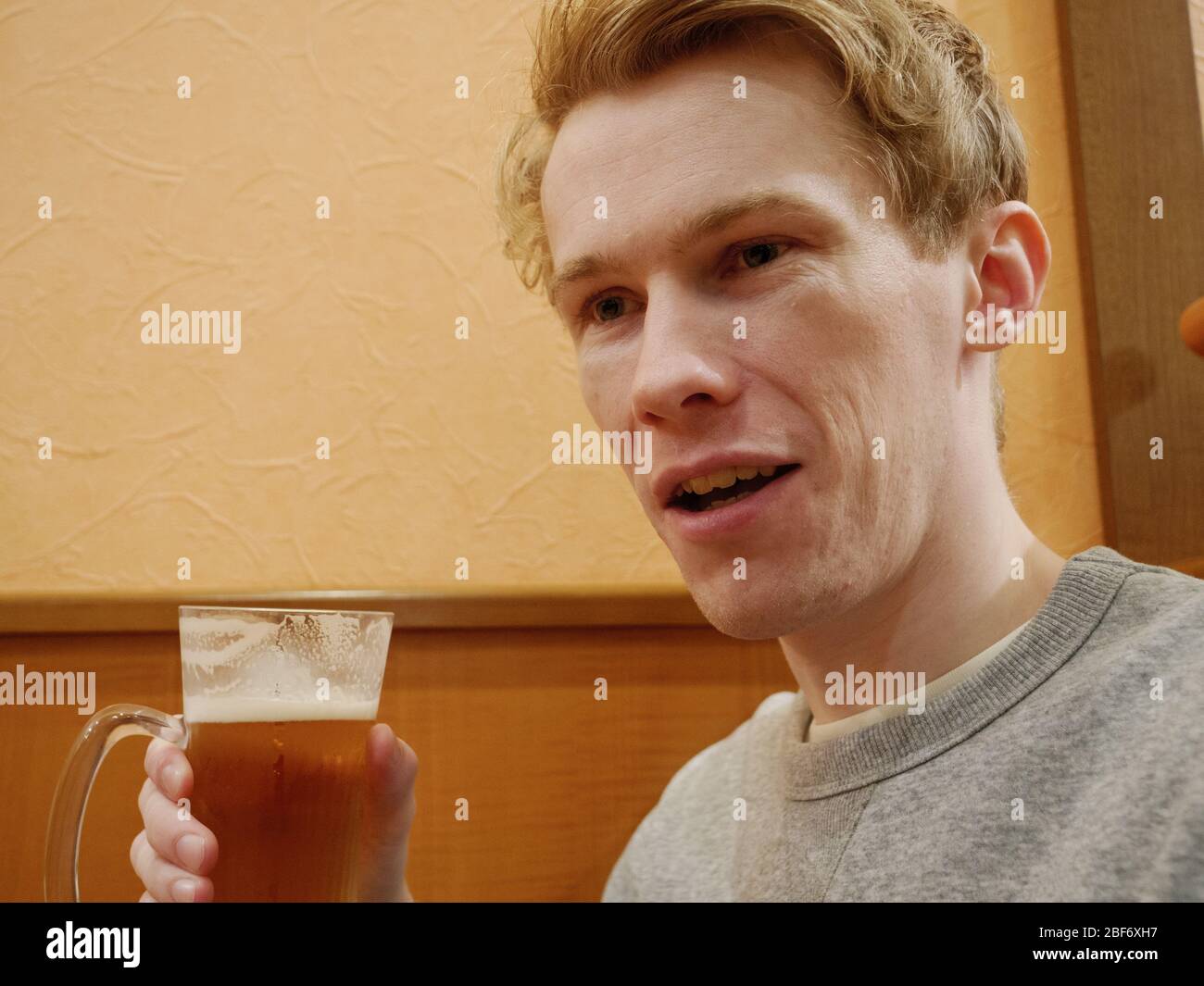 A handsome young man enjoying his beer Stock Photo - Alamy
