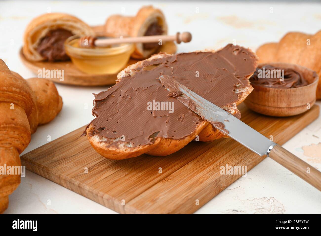 Tasty sweet croissant with chocolate on white background Stock Photo ...