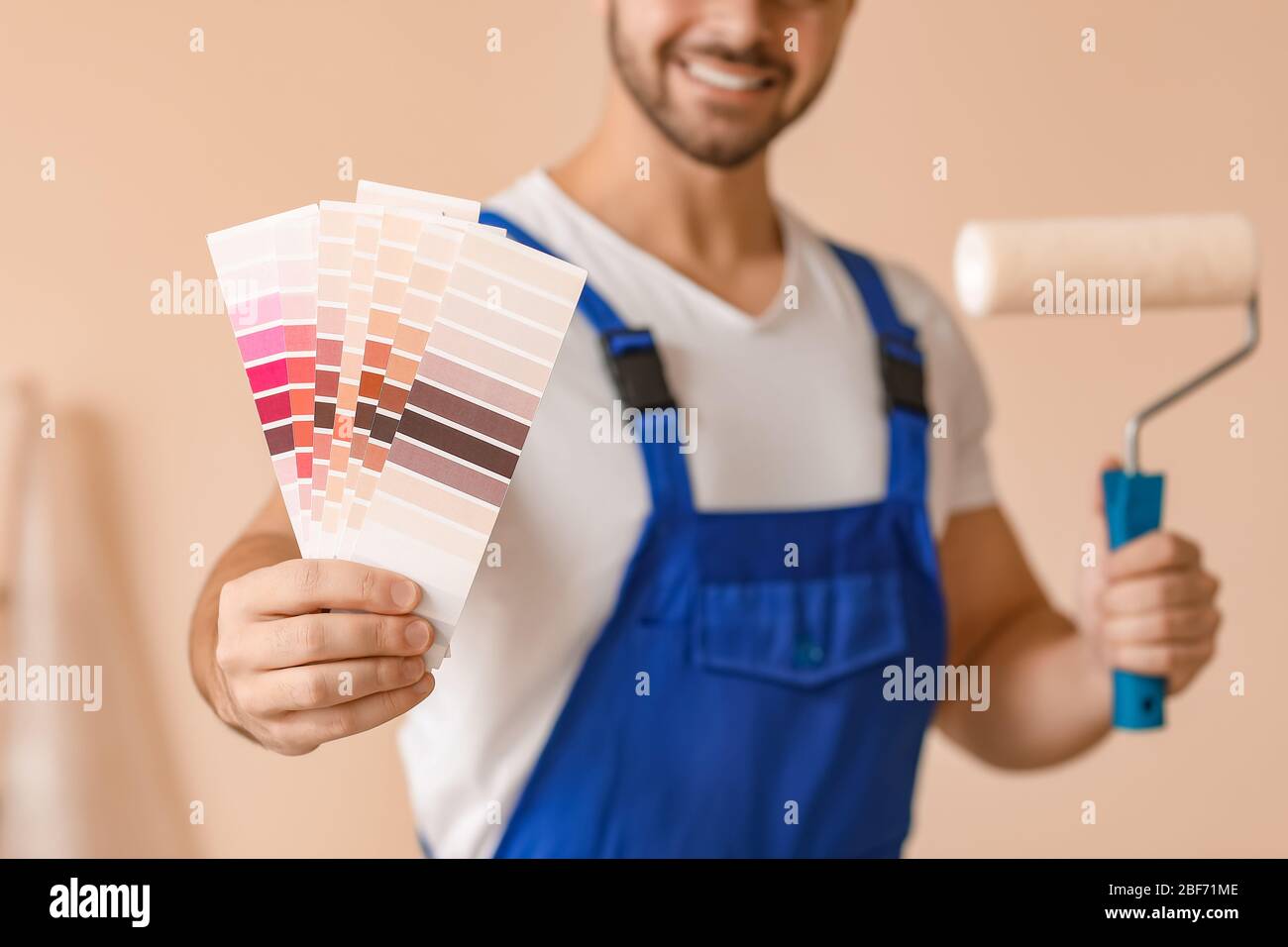 Painter with color samples in room Stock Photo - Alamy