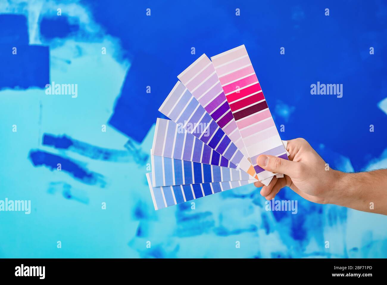 Male painter with color samples in room Stock Photo - Alamy
