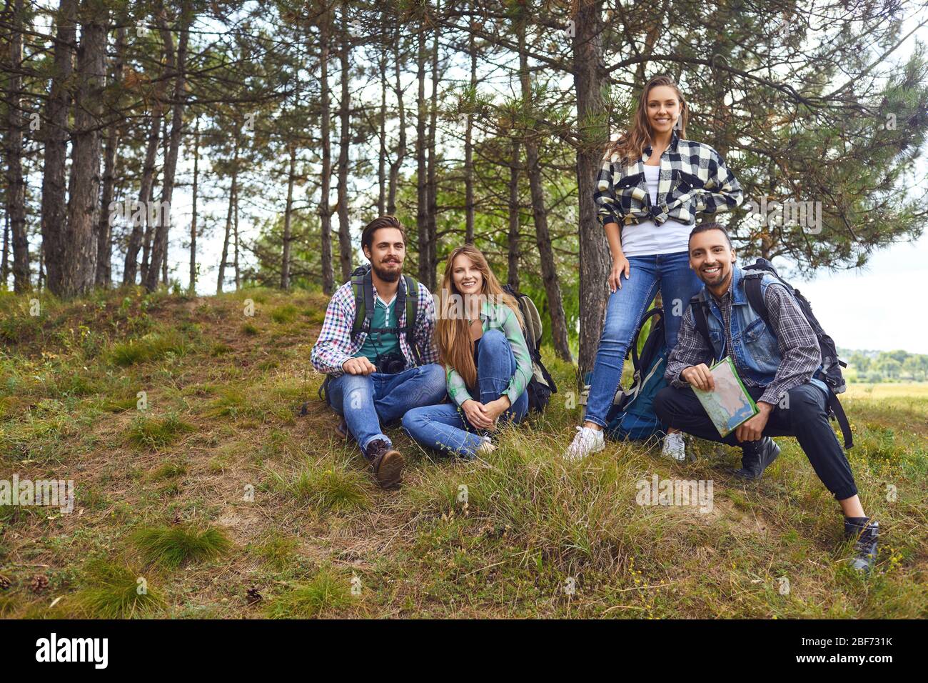 A group of tourists resting while sitting in a forest Stock Photo - Alamy