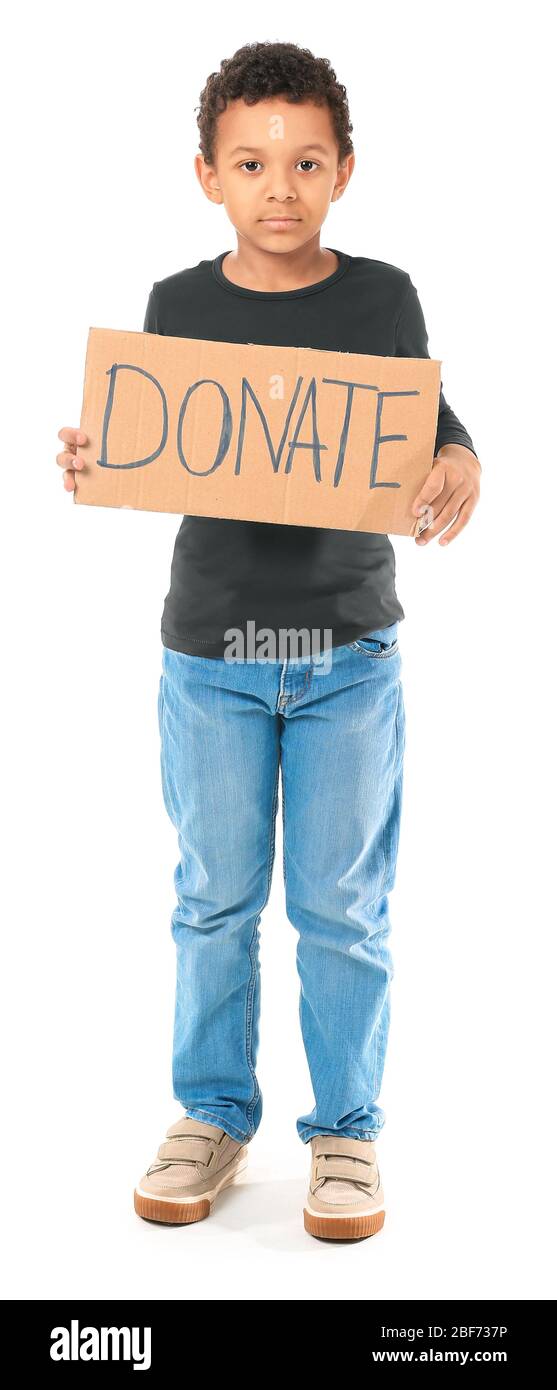 Little African-American boy holding cardboard with text DONATE on white ...
