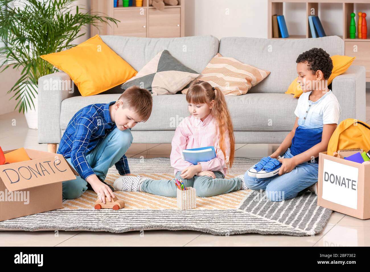 Little children with donations at orphan home Stock Photo - Alamy
