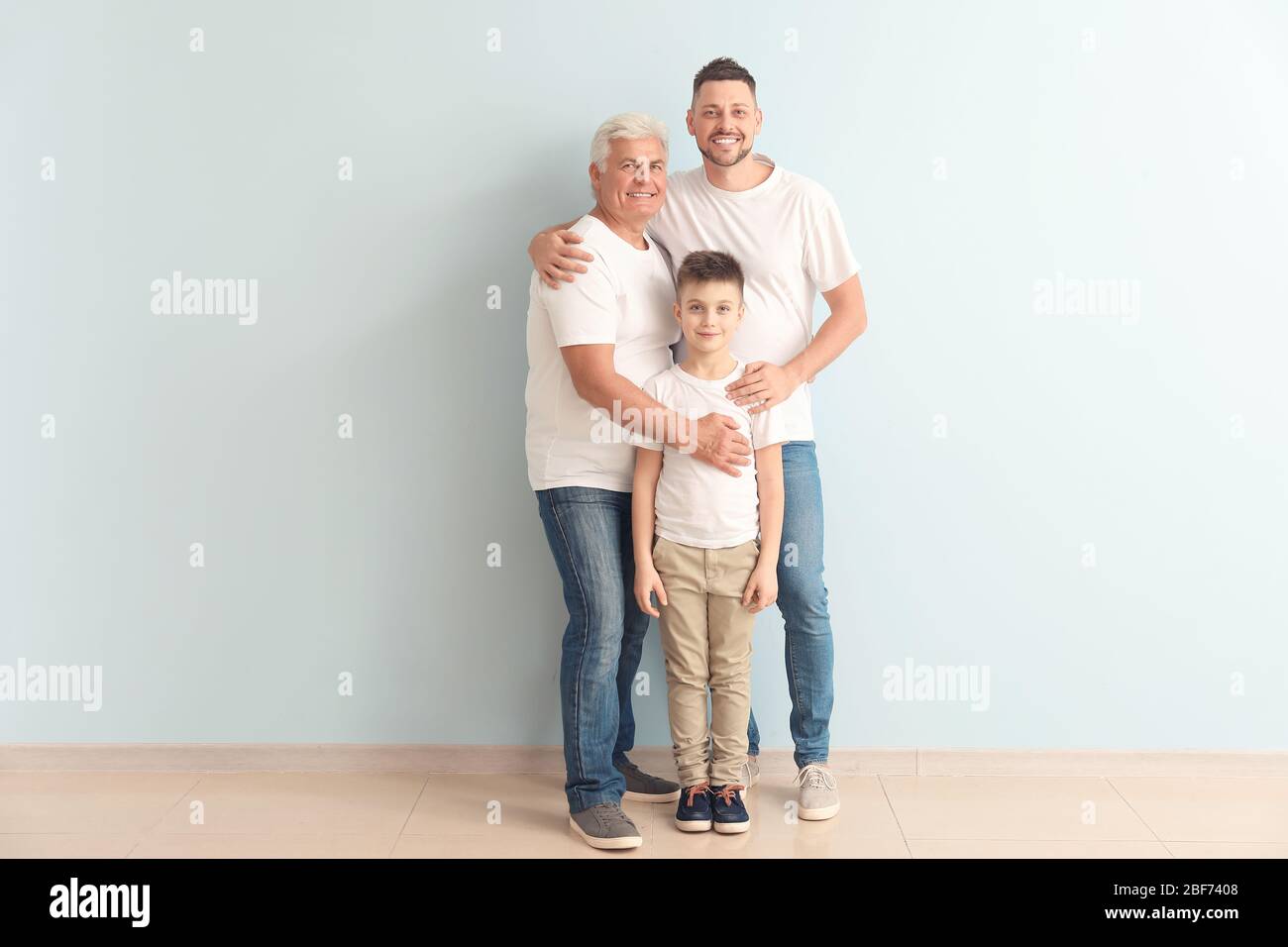Man with his father and son near color wall Stock Photo - Alamy