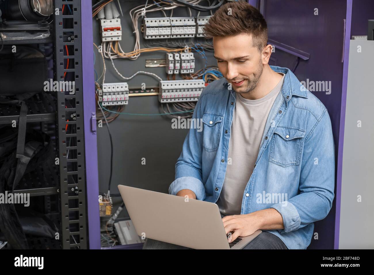 Technician engineer with laptop in server room Stock Photo - Alamy