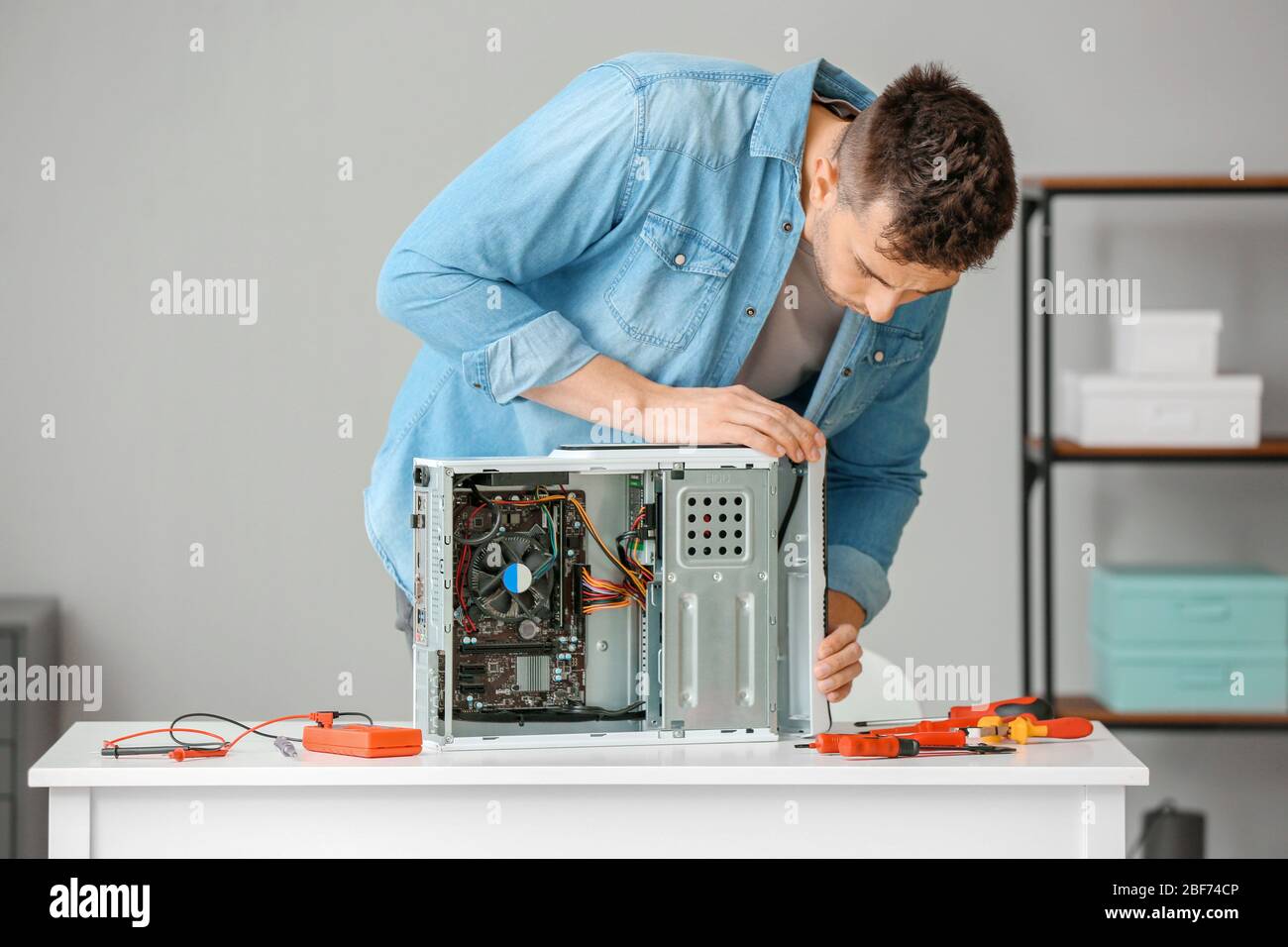 Electronic technician repairing computer in service center Stock Photo ...