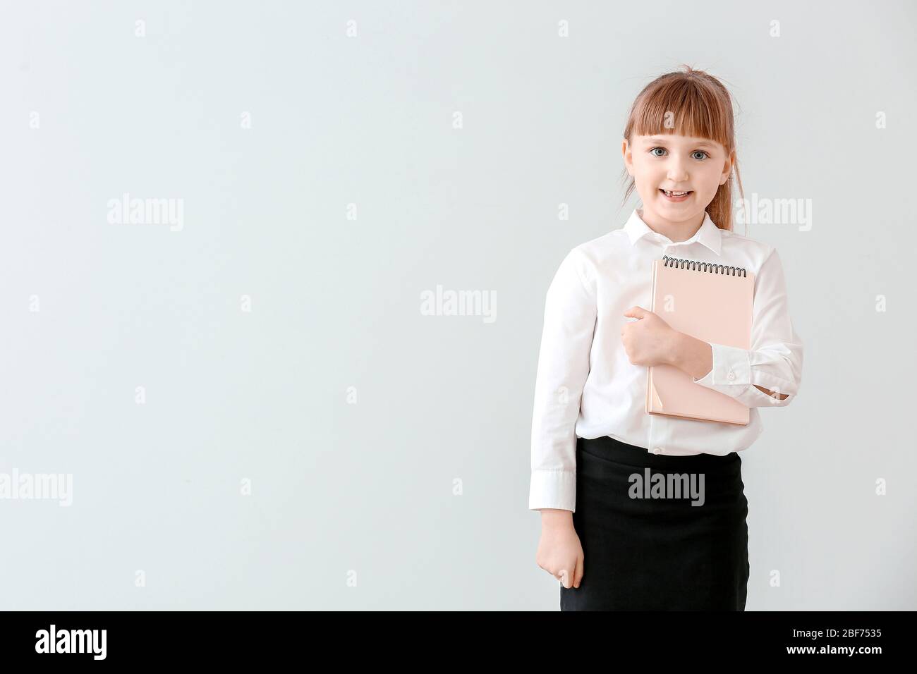Cute little waiter on light background Stock Photo - Alamy