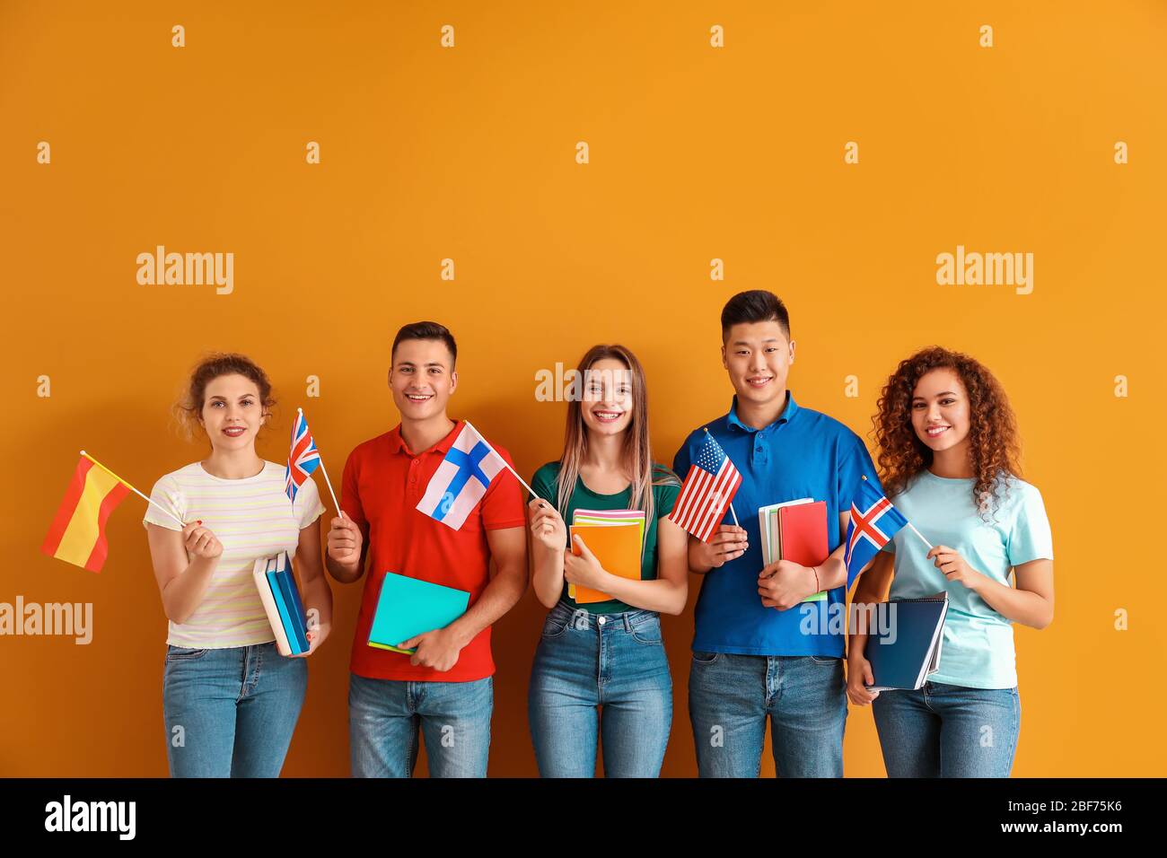 Young students of language school on color background Stock Photo - Alamy