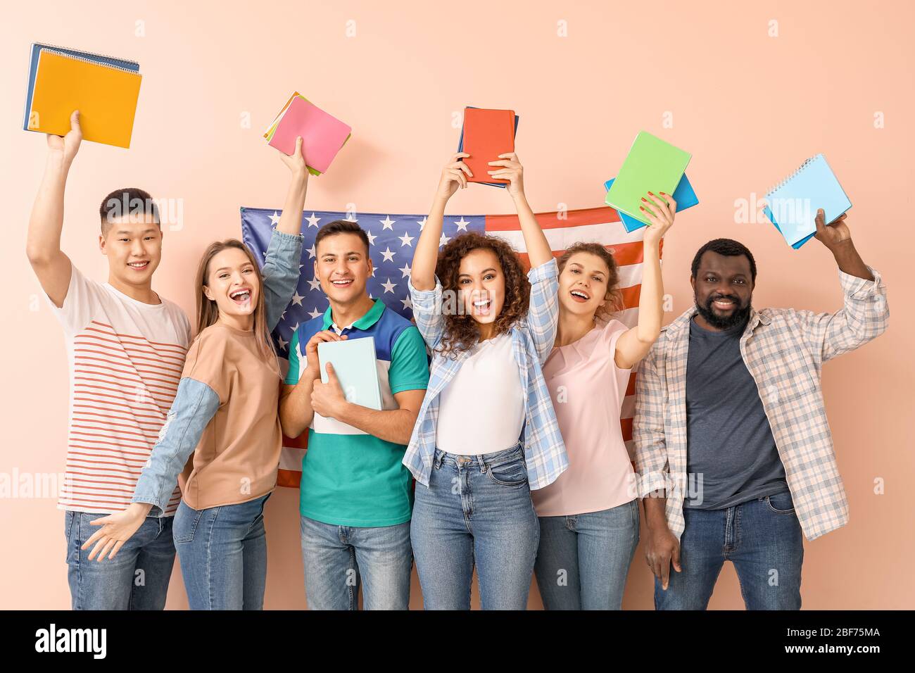 Young students of language school on color background Stock Photo - Alamy