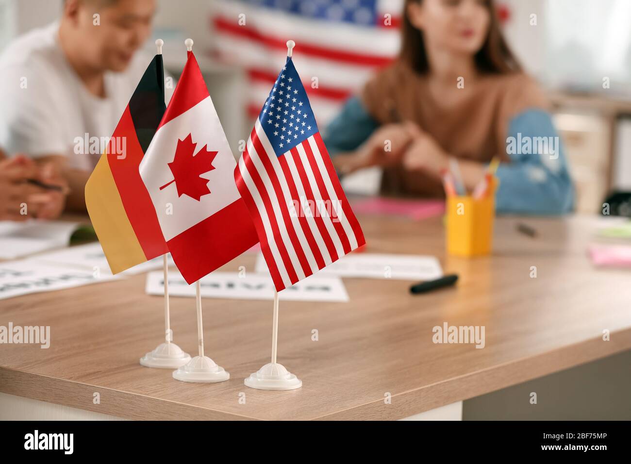 Flags of different countries on table at language school Stock Photo ...