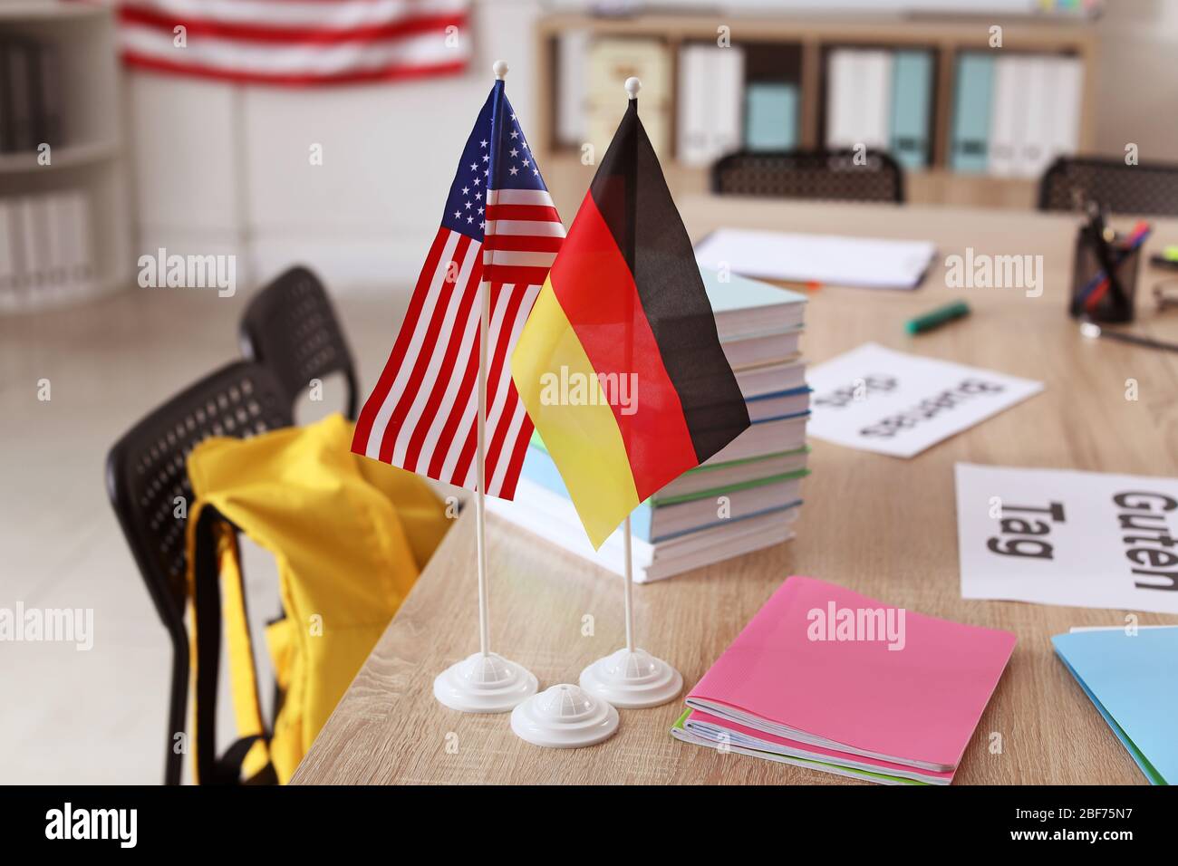 Flags of USA and German on table in language school Stock Photo - Alamy