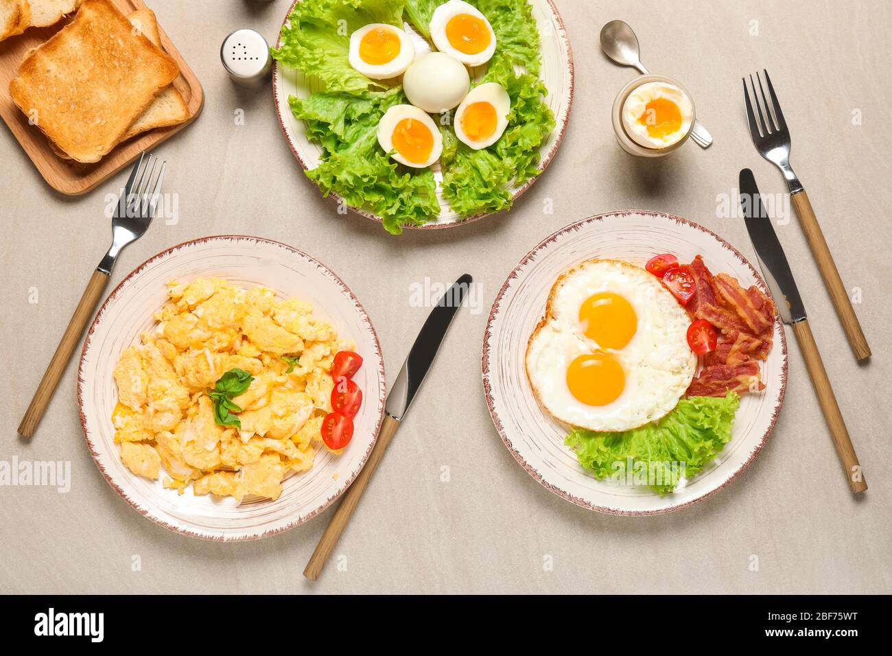 Different tasty dishes with eggs on table Stock Photo - Alamy