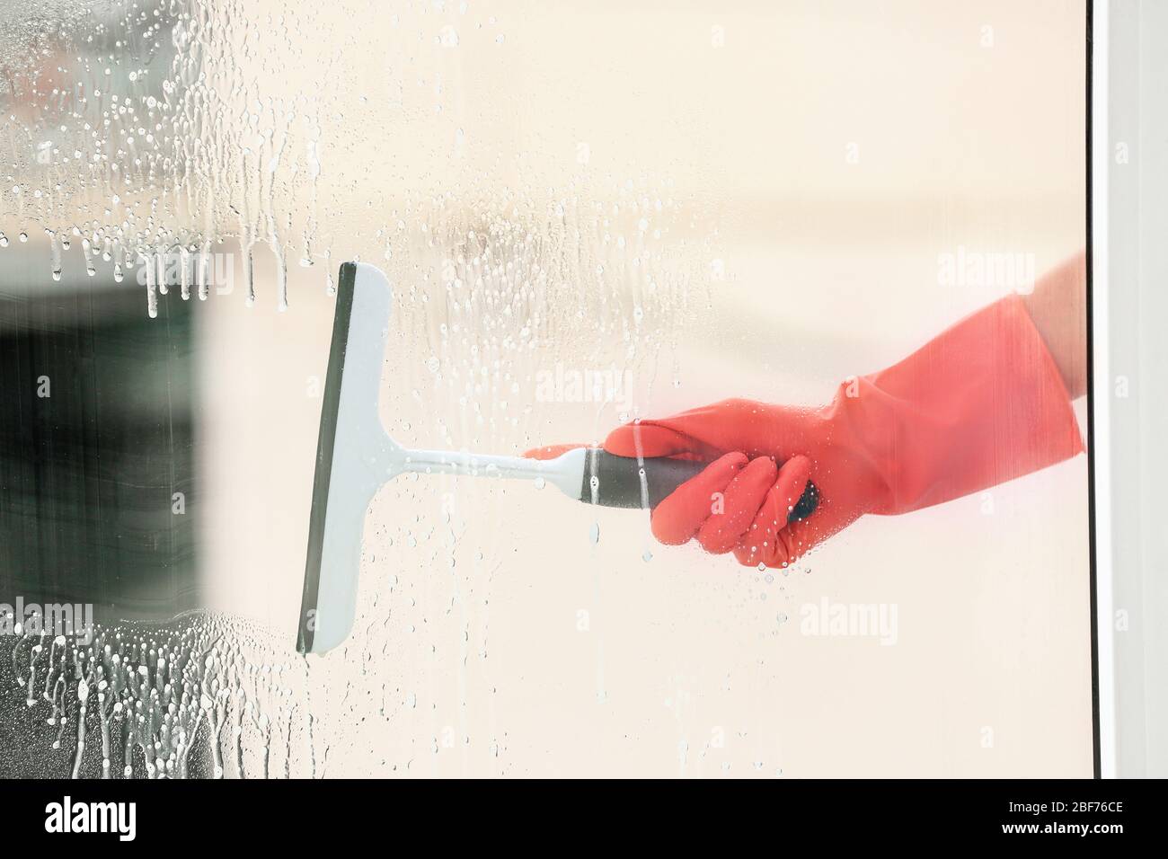 Janitor cleaning window in apartment Stock Photo - Alamy