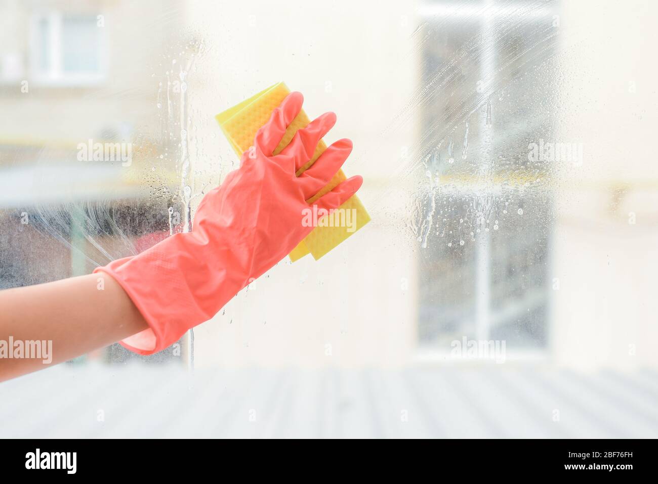 Janitor cleaning window in apartment Stock Photo - Alamy