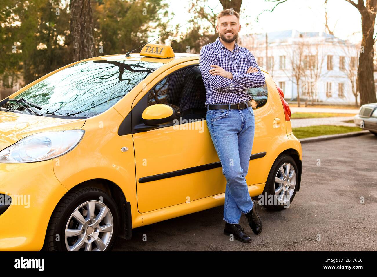 Portrait of handsome taxi driver outdoors Stock Photo - Alamy