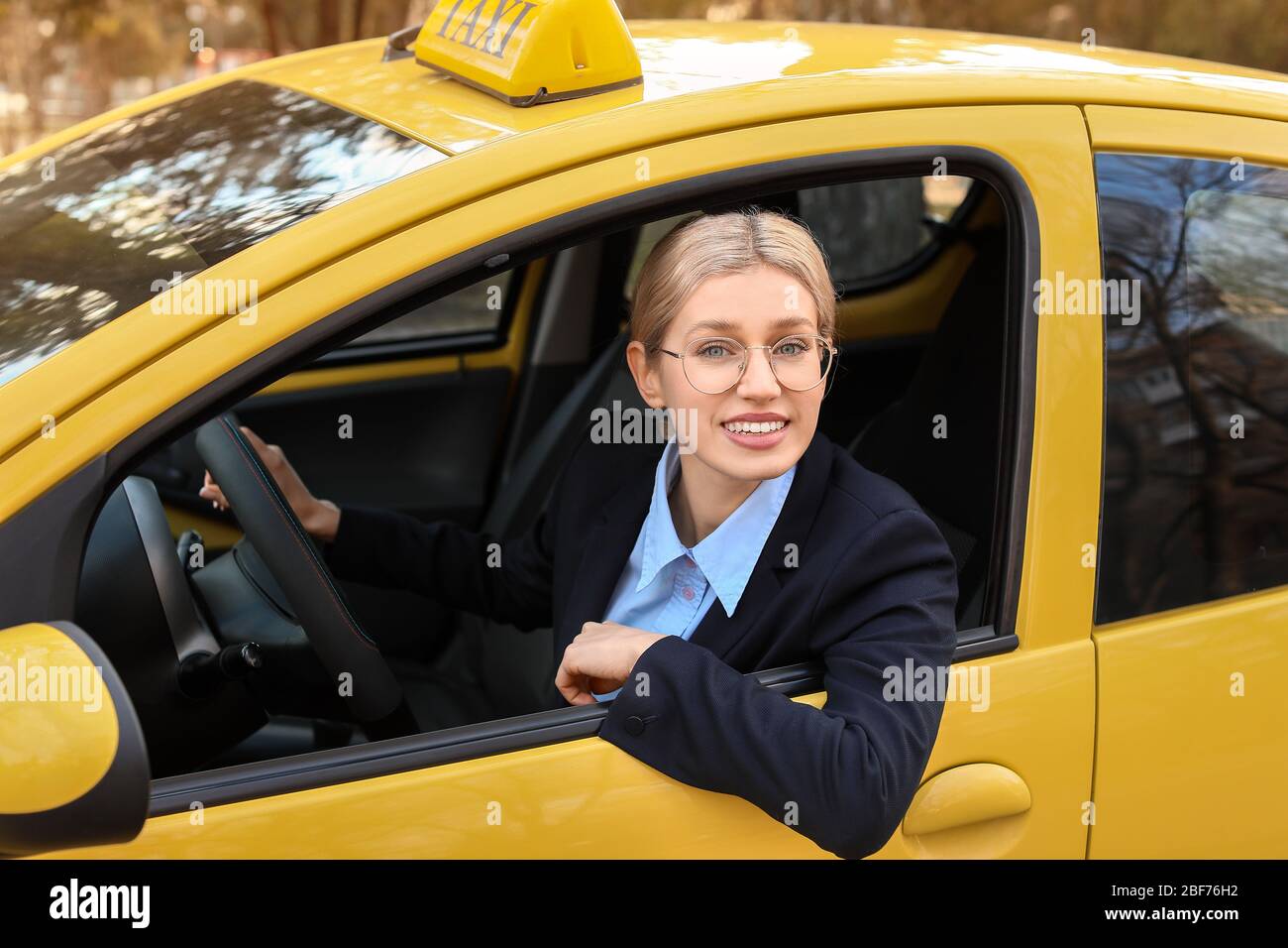 Beautiful woman driving taxi car Stock Photo - Alamy