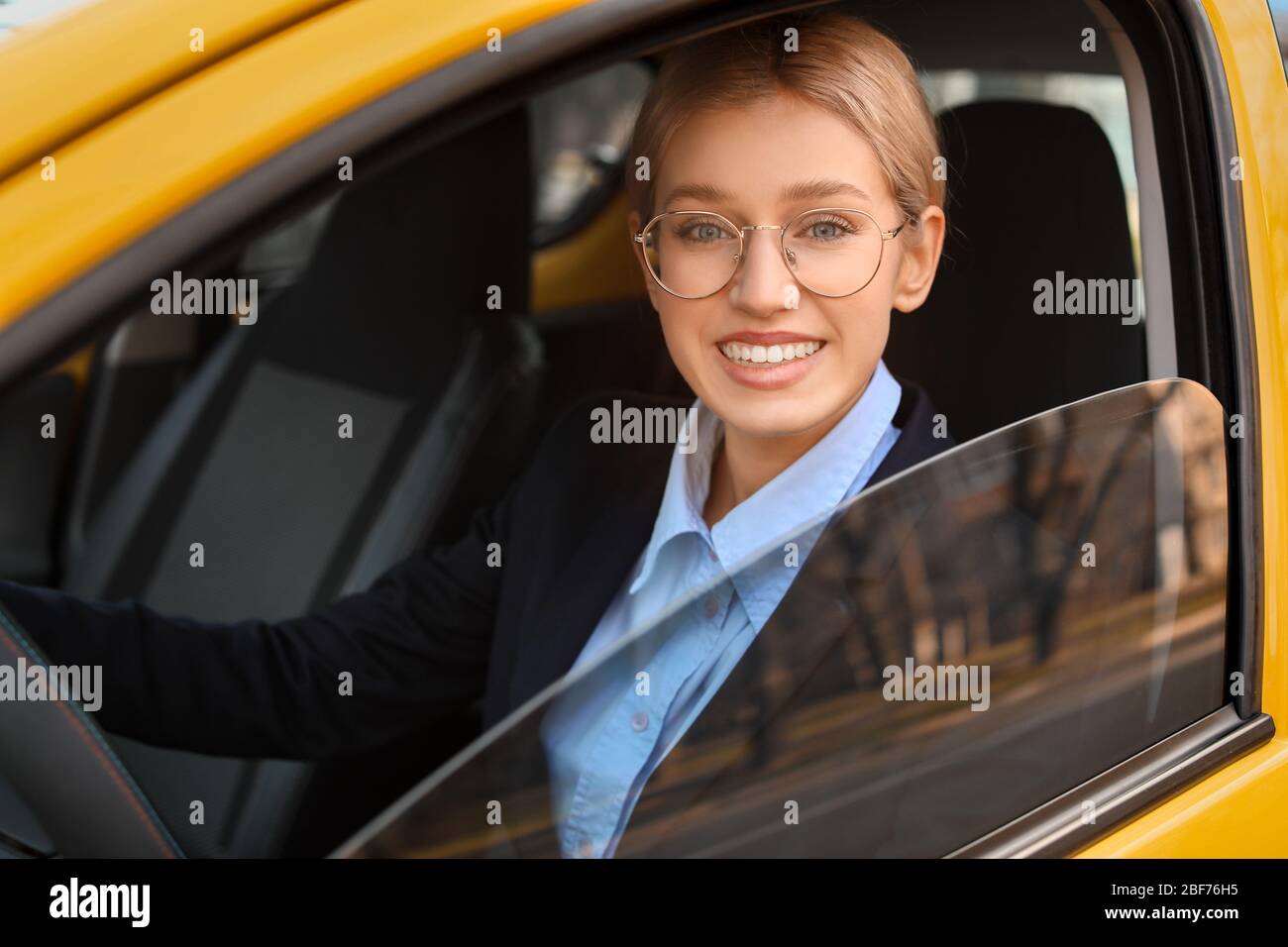 Beautiful woman driving taxi car Stock Photo - Alamy