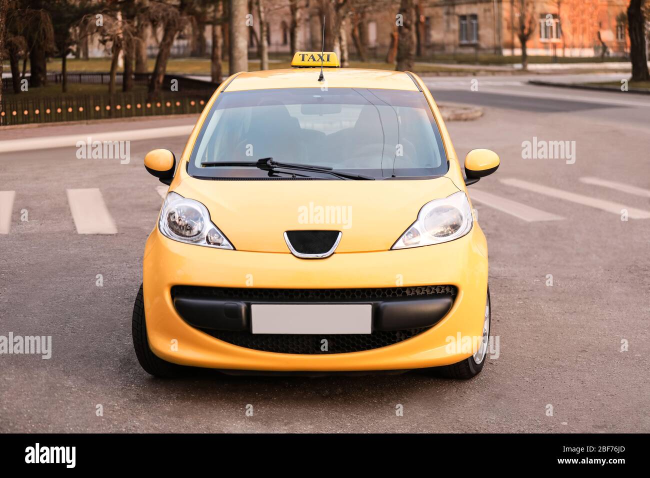 Modern taxi car on city road Stock Photo - Alamy