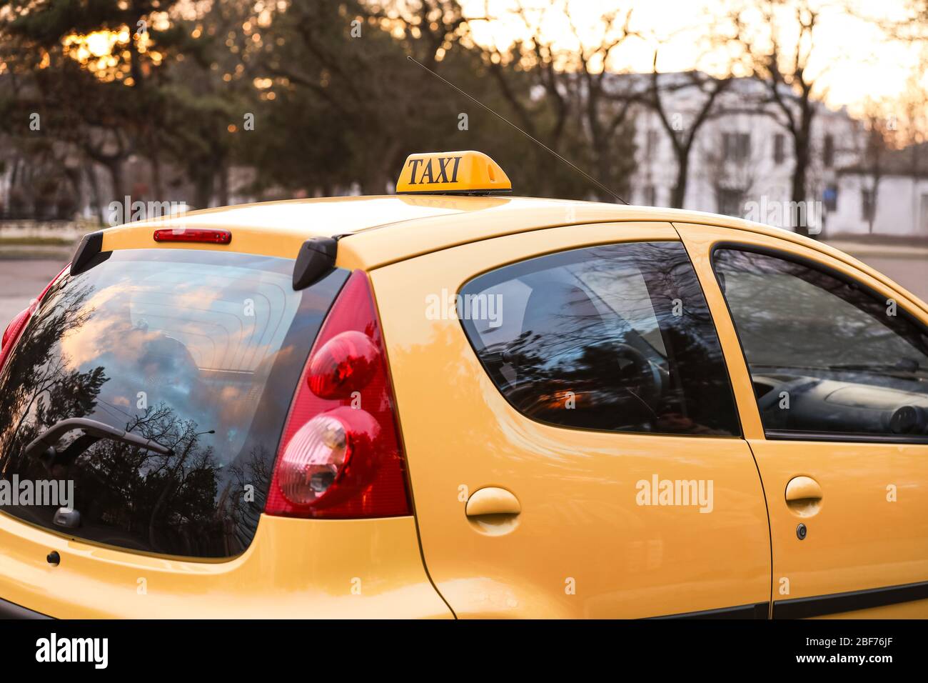 Modern taxi car on city road Stock Photo - Alamy