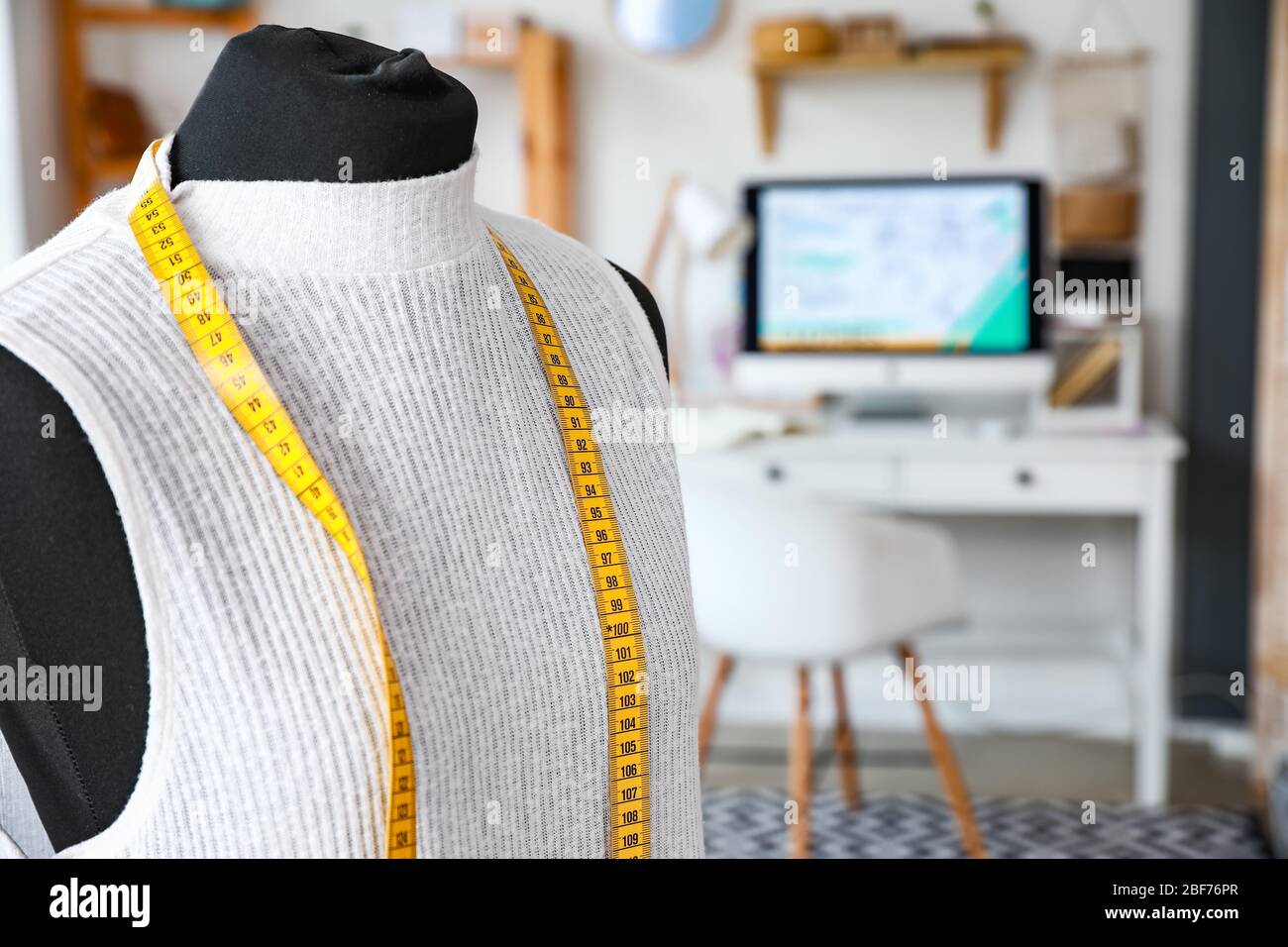 Mannequin with clothes and measuring tape in atelier Stock Photo - Alamy