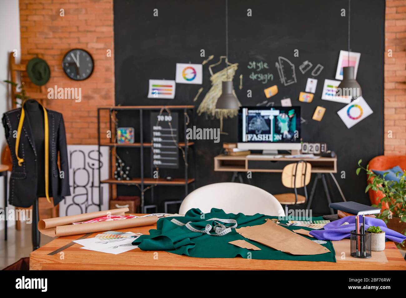 Interior of modern atelier with tailor's workplace Stock Photo - Alamy