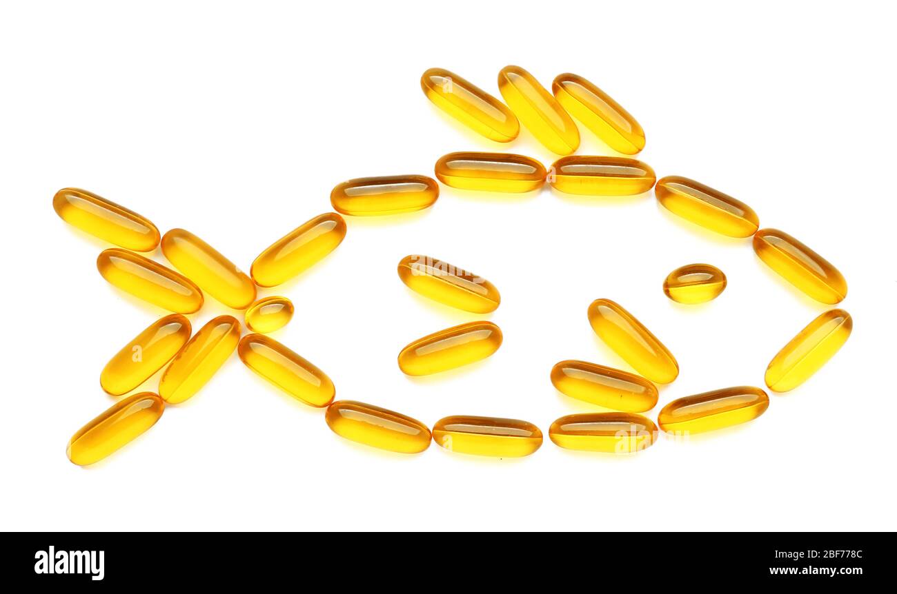 Fish shape made of oil pills on white background Stock Photo - Alamy