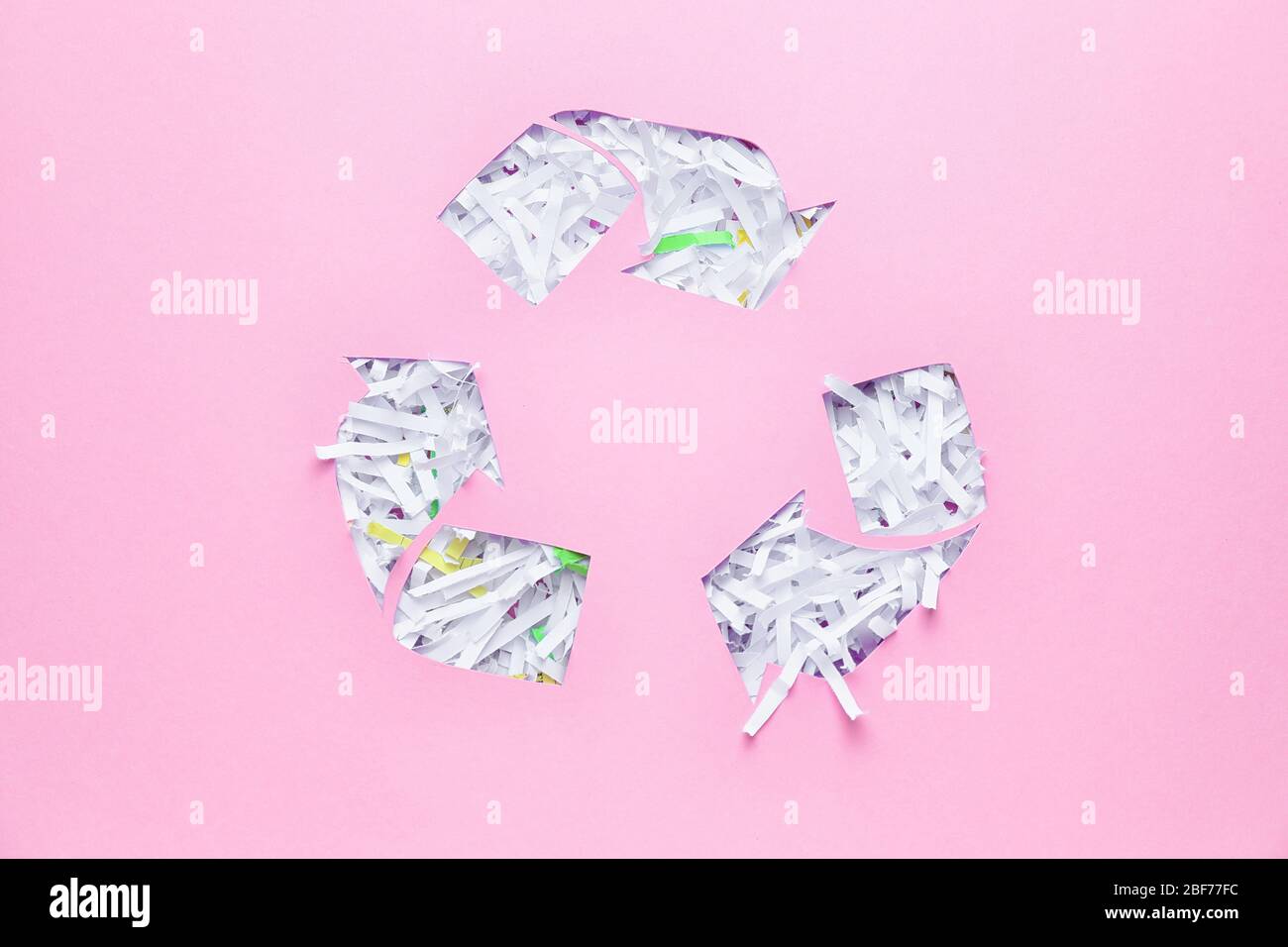 Recycling sign with shredded paper. Ecology concept Stock Photo - Alamy