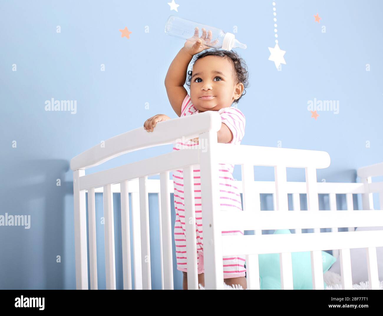 Cute African-American baby in crib Stock Photo - Alamy