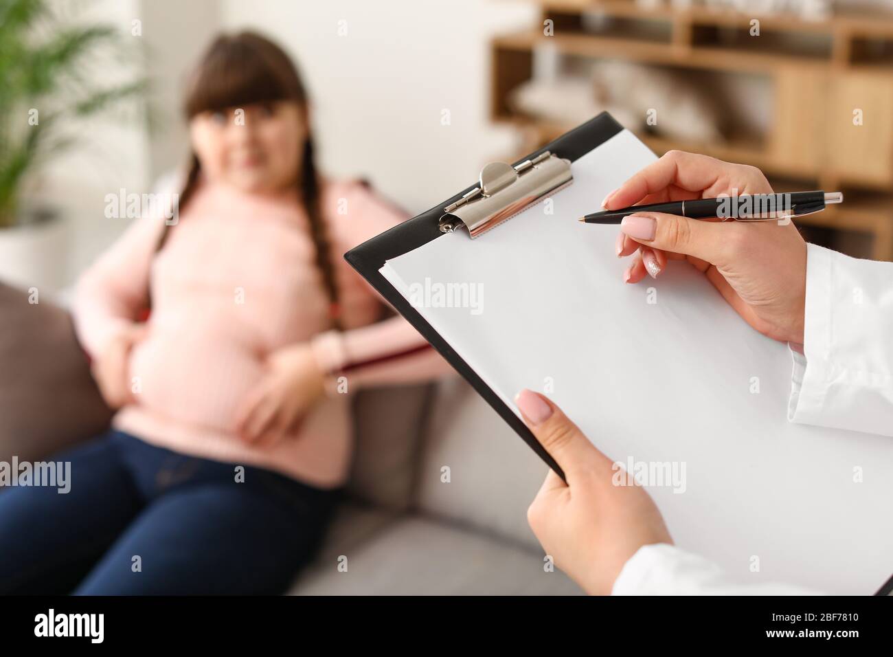 Doctor examining fat girl in clinic, closeup Stock Photo - Alamy