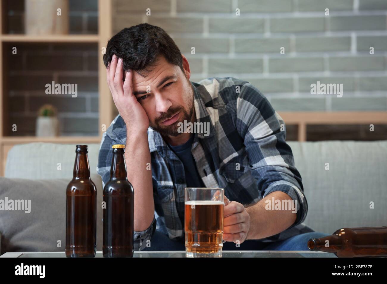 Man drinking beer at home. Concept of alcoholism Stock Photo - Alamy