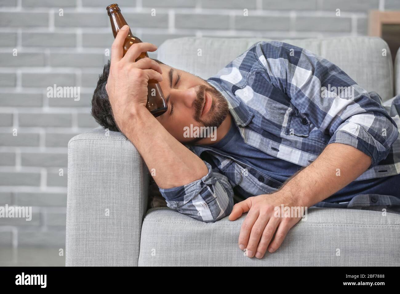 Man drinking beer at home. Concept of alcoholism Stock Photo - Alamy