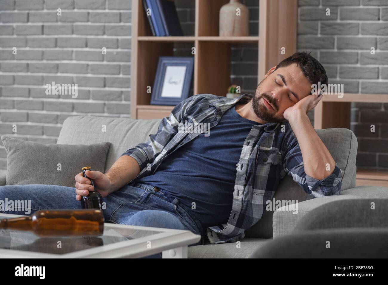 Man drinking beer at home. Concept of alcoholism Stock Photo - Alamy