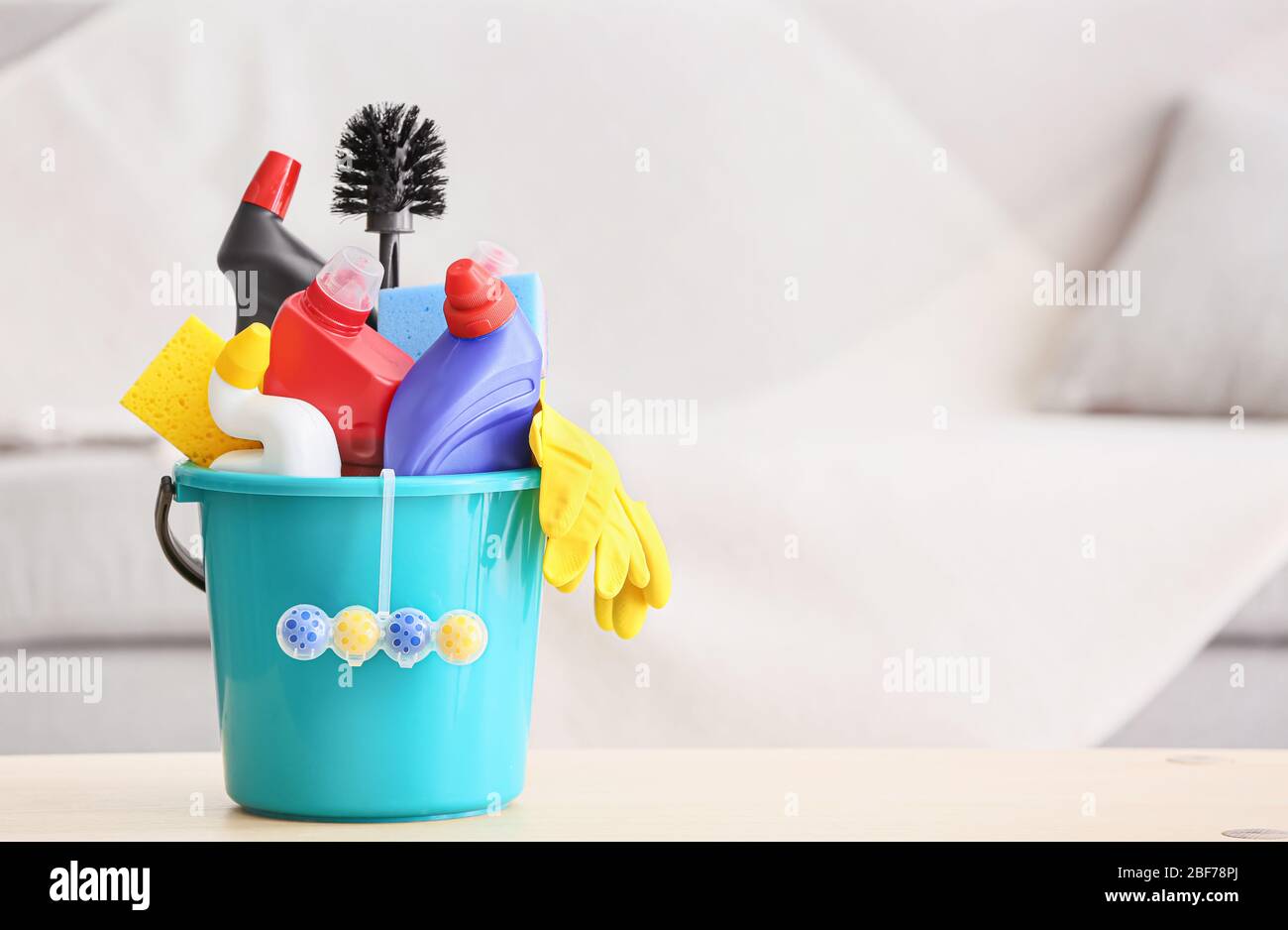 Set of cleaning supplies on table in room Stock Photo - Alamy