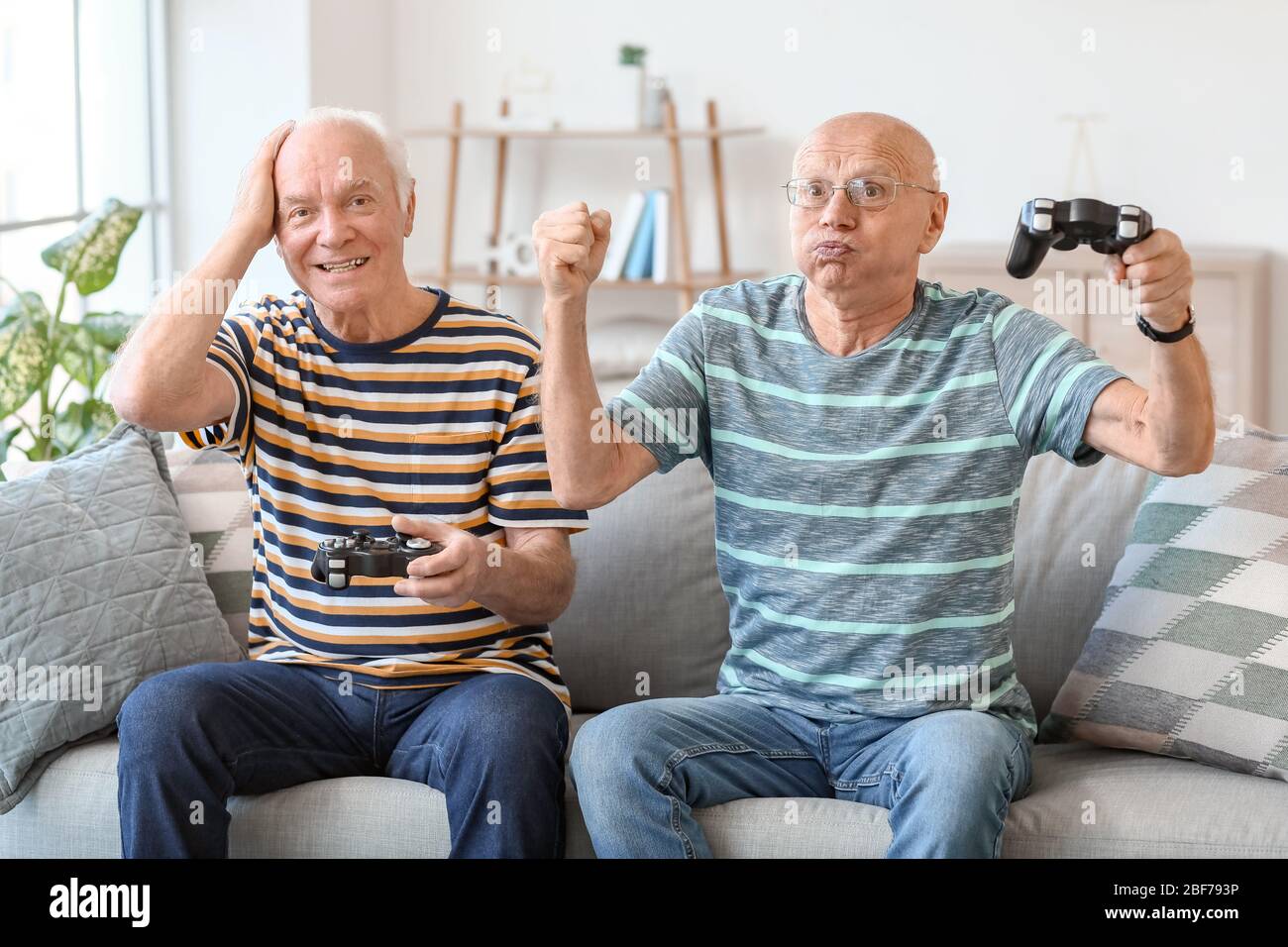 Elderly men playing video games at home Stock Photo - Alamy