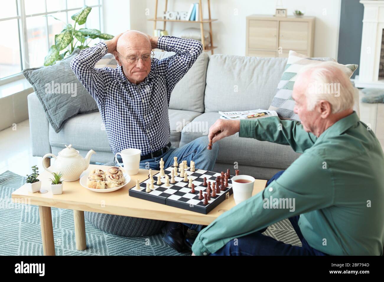 Elderly men playing chess at home Stock Photo - Alamy